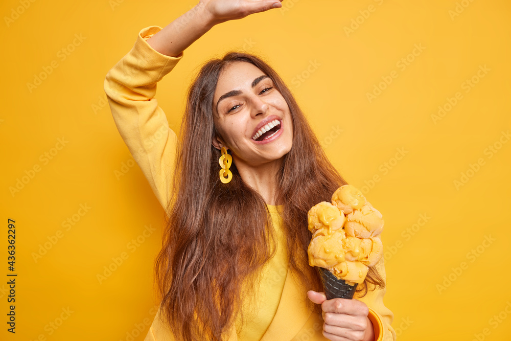 Horizontal Shot Of Positive Carefree Good Looking Woman Dances And