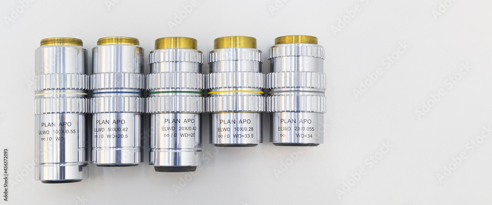 Detail of microscope lens on an white background.Closeup of microscope ...