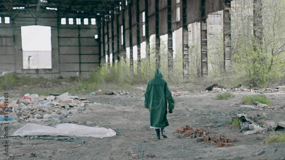 Radioactive zone. Human in safety uniform and gas mask in abandoned ...