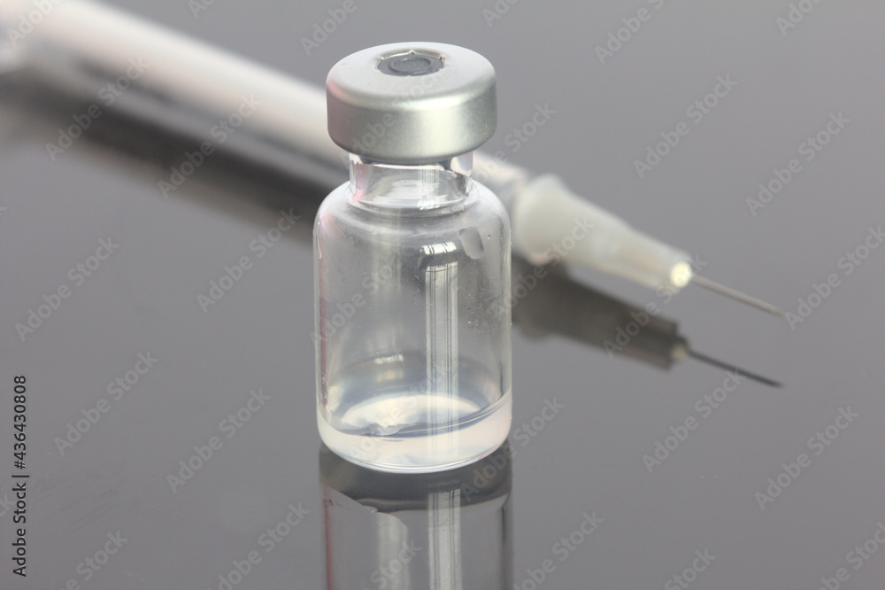 Covid19 Vaccine vial with needle and syringe Stock Photo | Adobe Stock