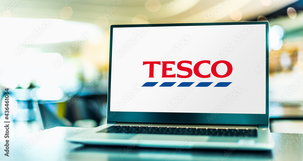 Laptop computer displaying logo of Tesco Stock Photo | Adobe Stock