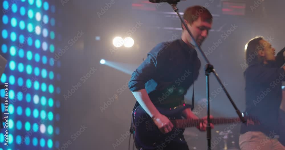 Live concert. Expressive guitarist's performance on stage. The guy ...