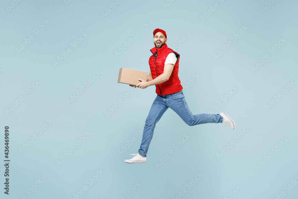 Full size body length side view delivery guy employee man in red cap ...