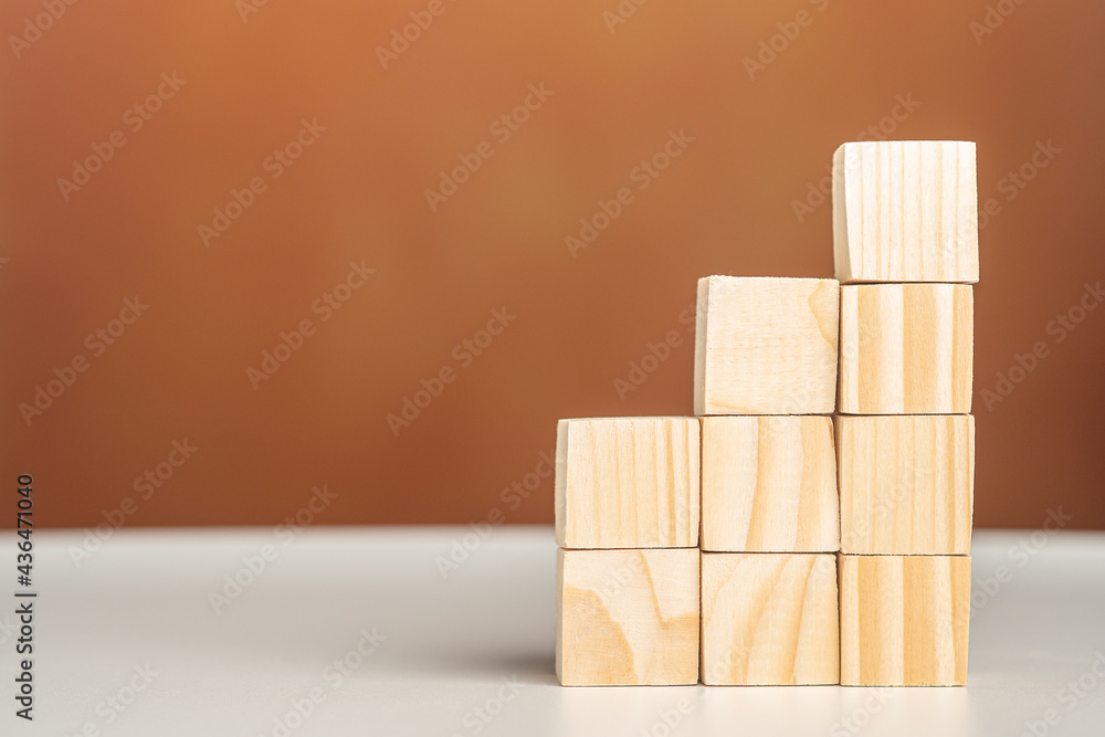 Side view of stacked blank wooden blocks on a white table with a vintage background. Space for ...