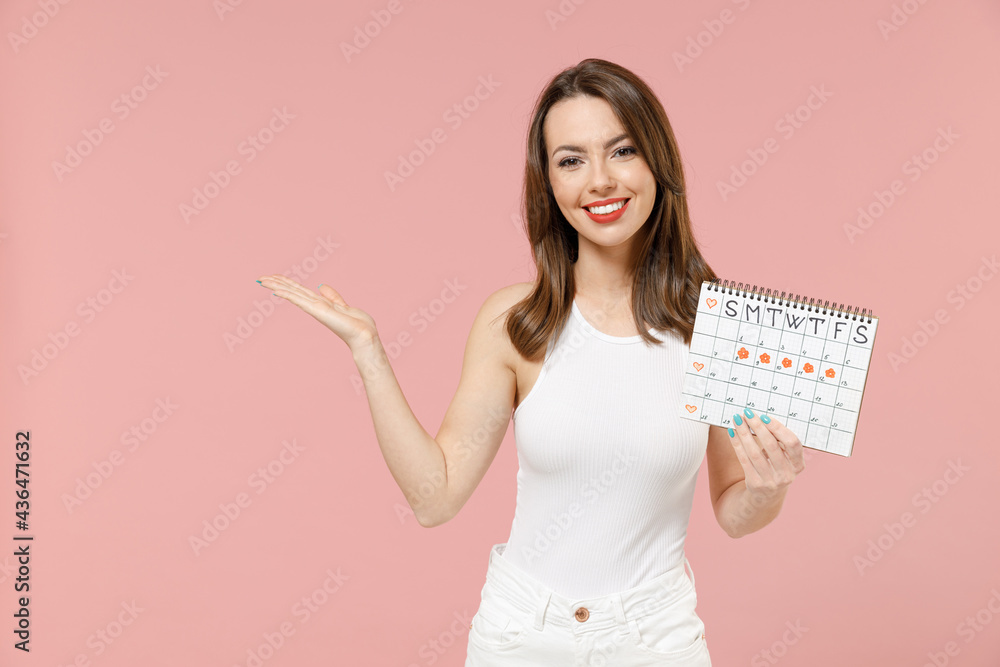 Young woman in white clothes hold female periods calendar for checking ...