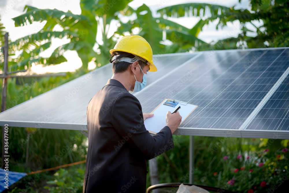 Young engineer pictured examining the operation of photovoltaic ...