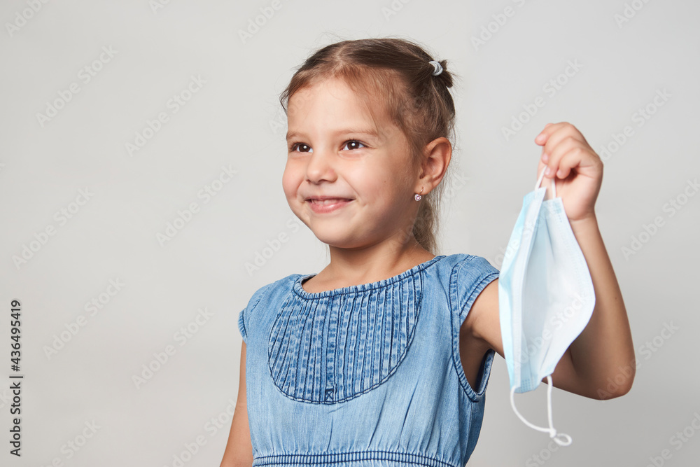 Little girl wearing face mask on a white background Stock Photo | Adobe ...