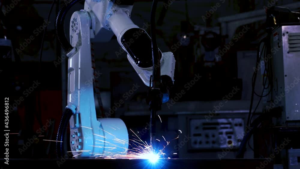 Vidéo Stock Fire spark from welder robotic machine. Robot arm working ...