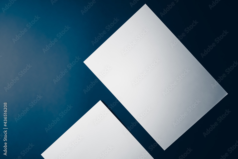 Blank A4 paper, white on blue background as office stationery flatlay ...