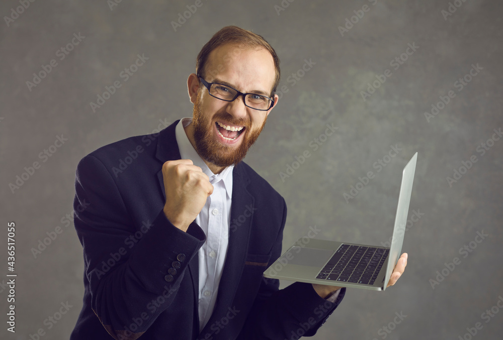 Funny happy excited bearded guy in office suit and nerd glasses holding ...