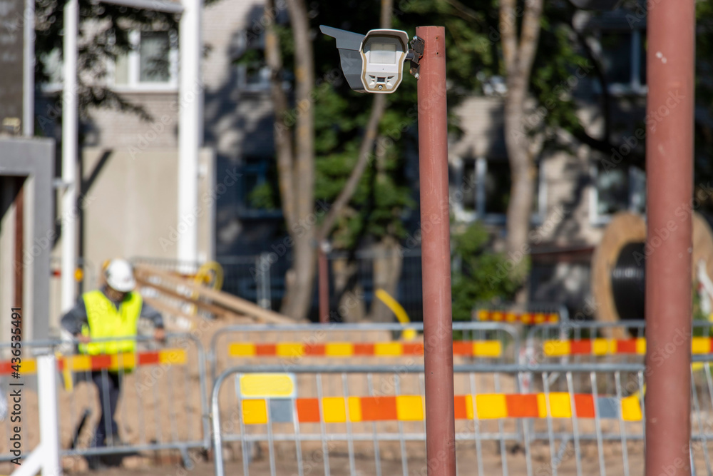 The outdoor IP motion sensor on the metal pipe. Construction site alarm ...