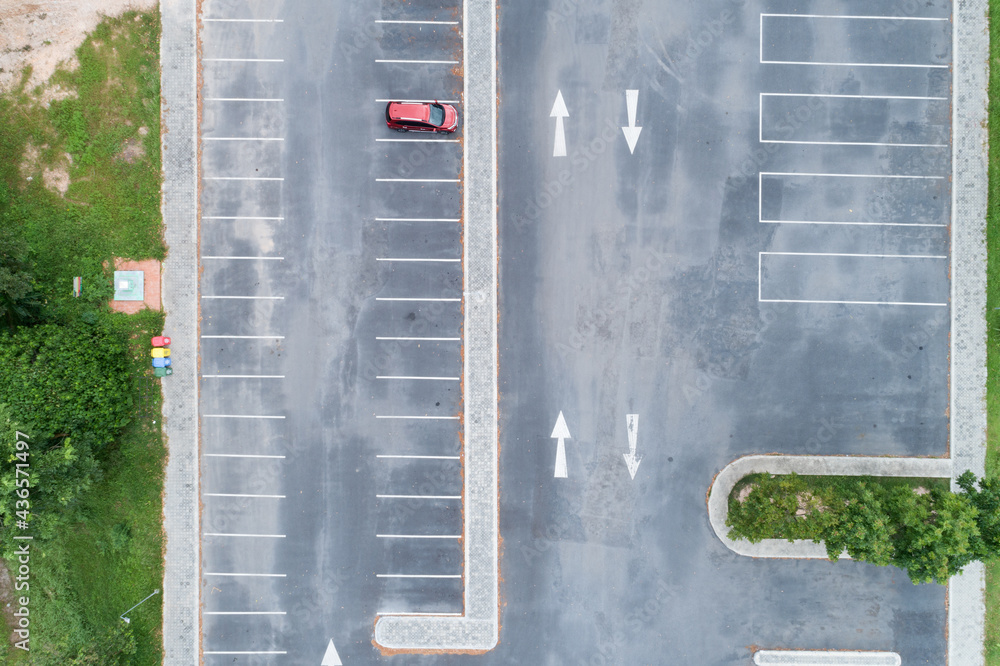 Aerial view top down of red SUV car parked at concrete car parking lot ...