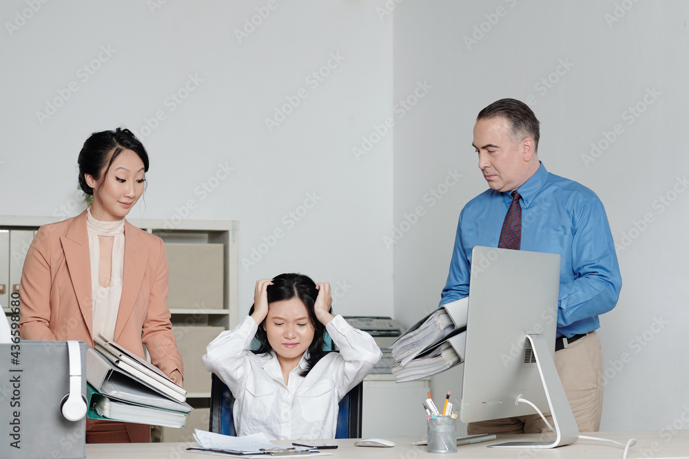 Young businesswoman stressed and overwhelmed with ammount of work, her ...