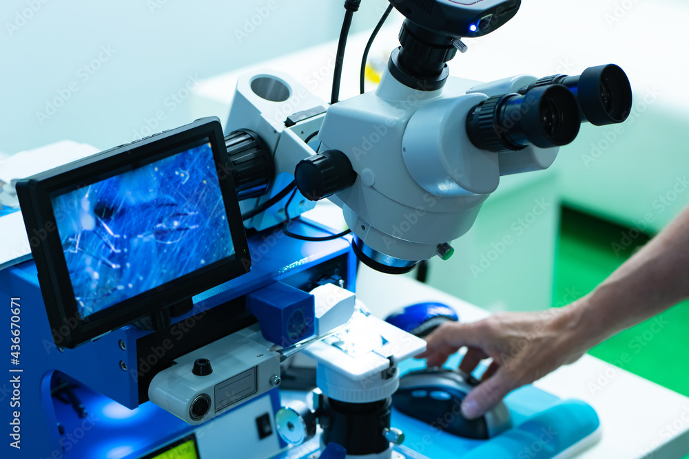 Computer Expert Examines A Microchip Transistor Pcb Under A Microscope