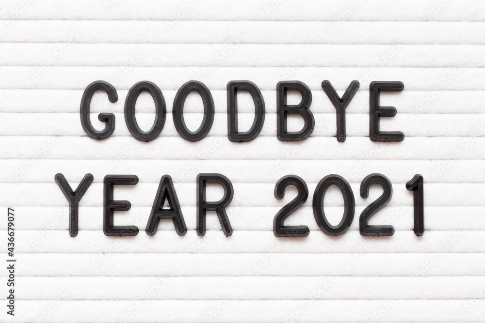 Black color letter in word goodbye year 2021 on white felt board ...