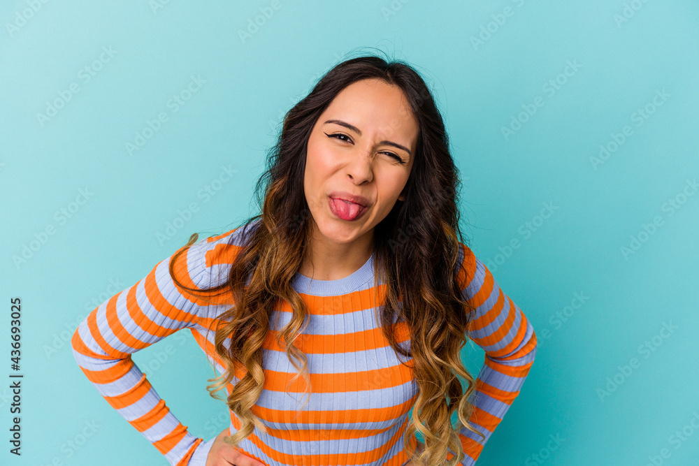 Young mexican woman isolated on blue background funny and friendly ...