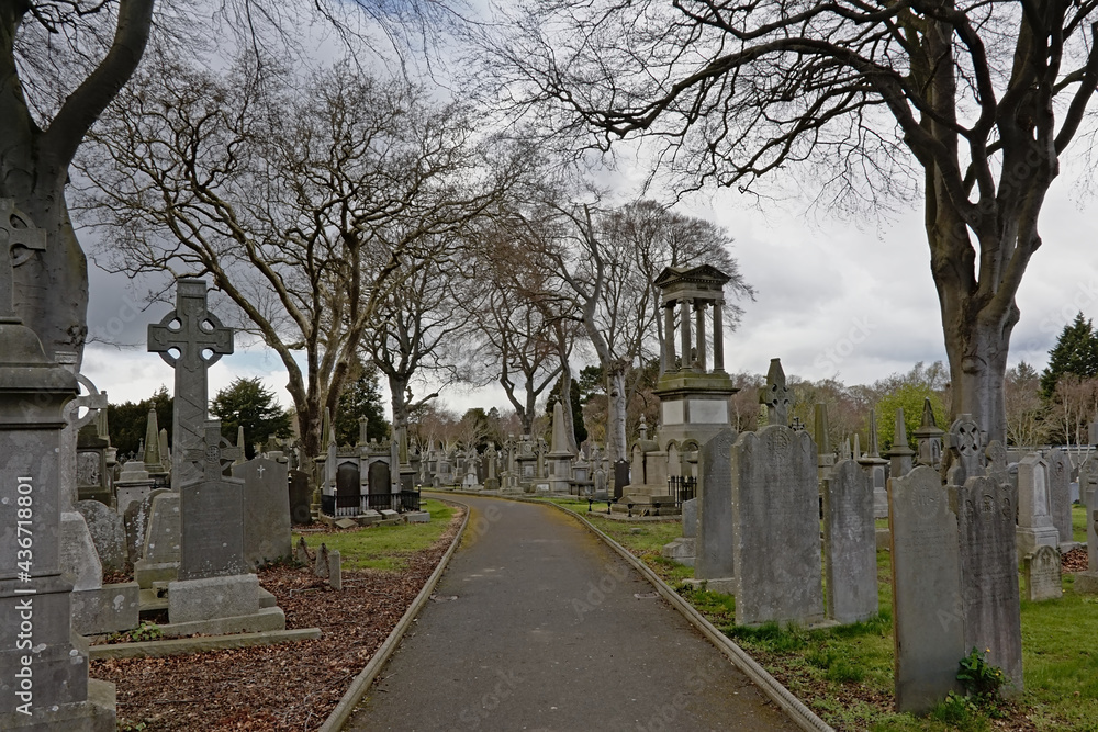 Old historic grave monuments with crosses in Glasnevin, green cemetery ...