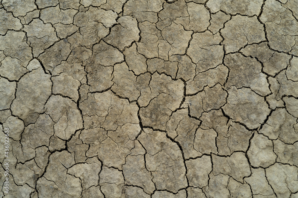 Dramatic landscape of dry and cracked land in an arid area caused by ...