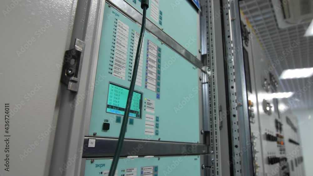Glowing screen on cabinet with switchboard in modern electricity ...