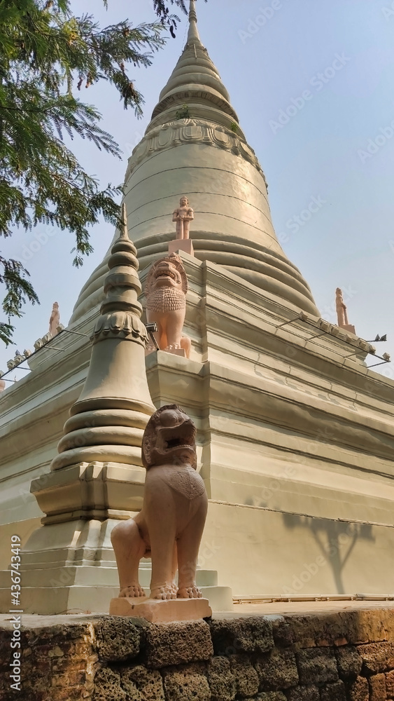 View of the stupa and sculptures in Wat Phnom Buddhist Religious Temple ...