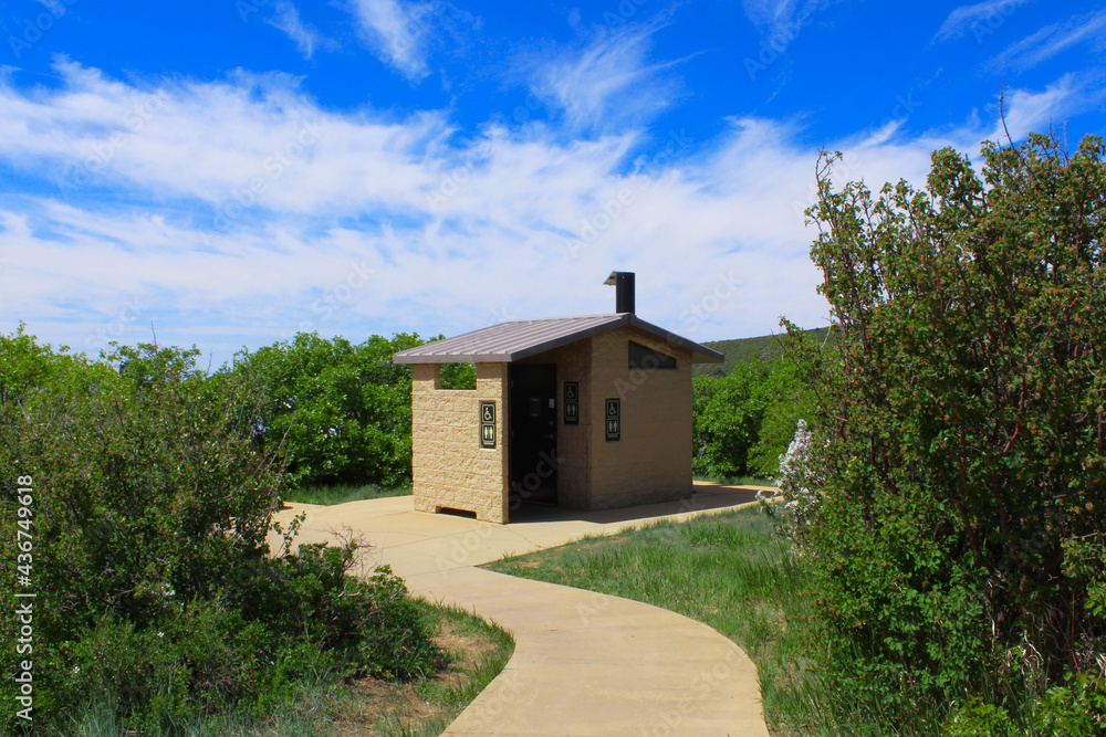 Public restroom building along a hiking trail with a toilet sign on the ...