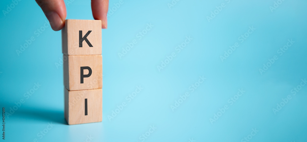 Banner KPI concept with wooden block on blue background. Key ...