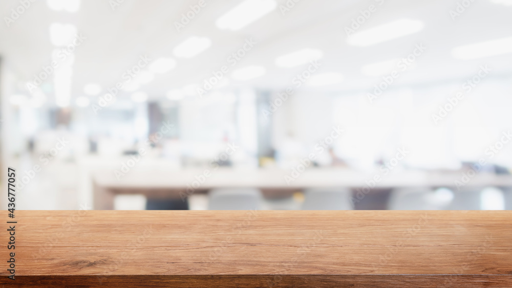 Empty wood table top and blur modern office space building background ...