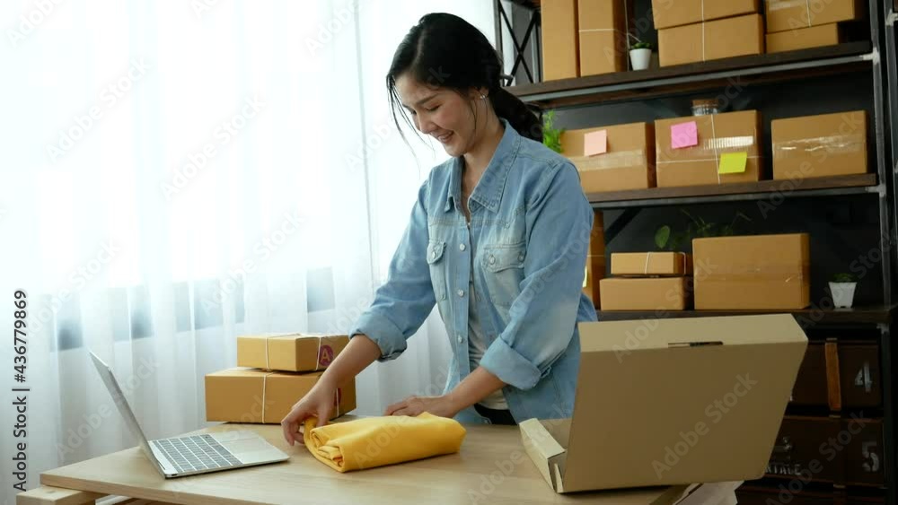 Woman packing box on table checking goods package delivery shipping to ...