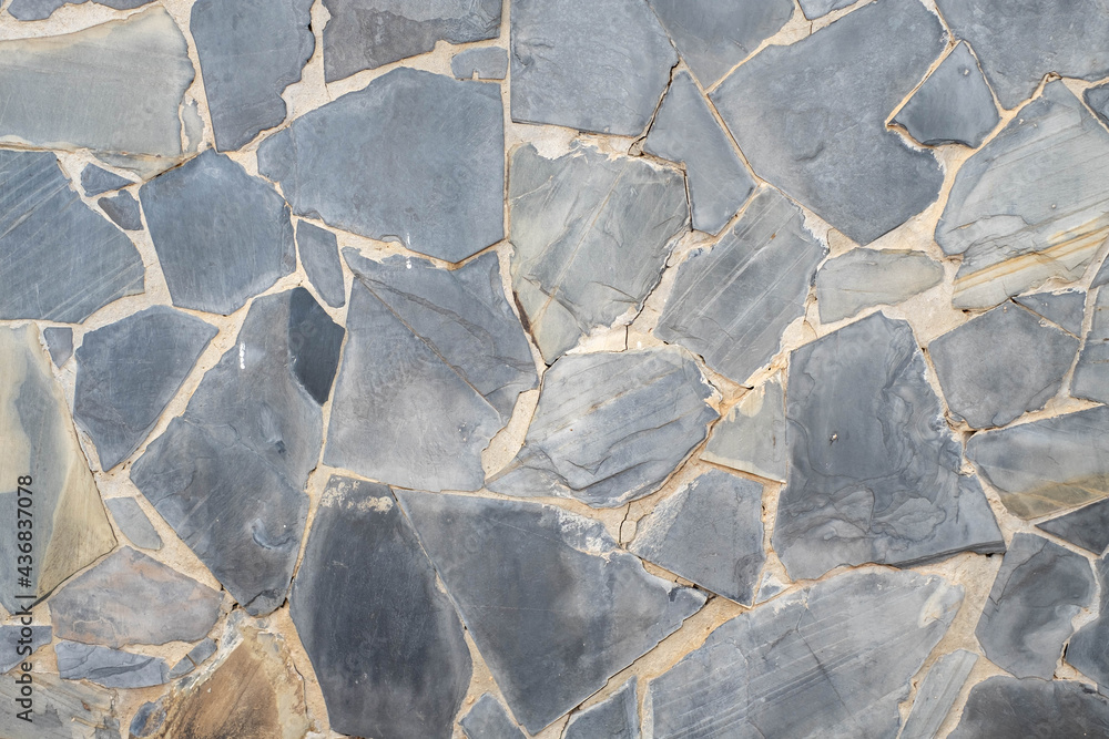 The walls are covered with stone cladding, with a free pattern as a ...