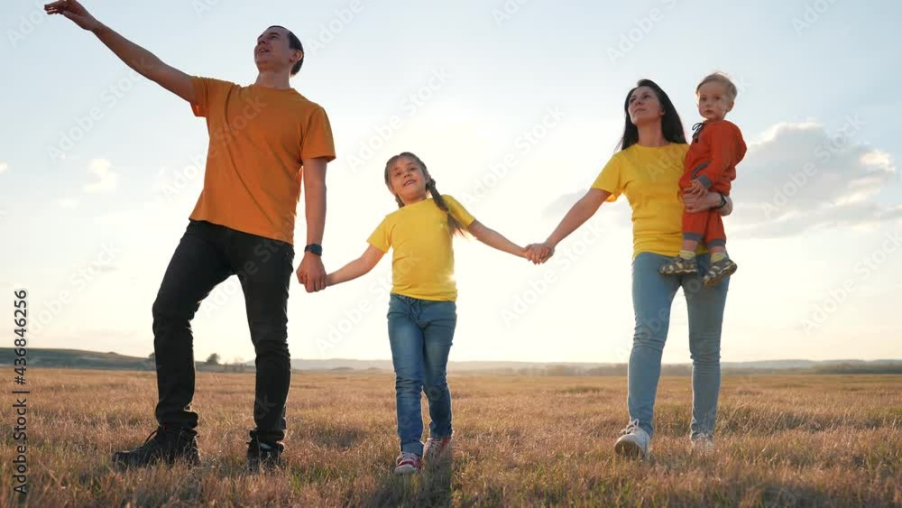 Happy family walks in park at sunset. Active teamwork. Mom, dad and ...