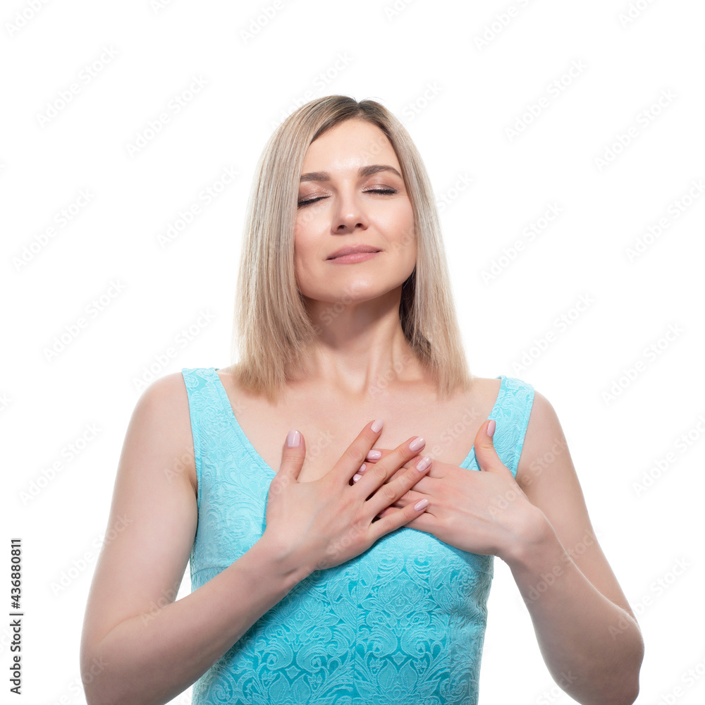 Pretty woman with hands on chest and grateful gesture on face, feels ...