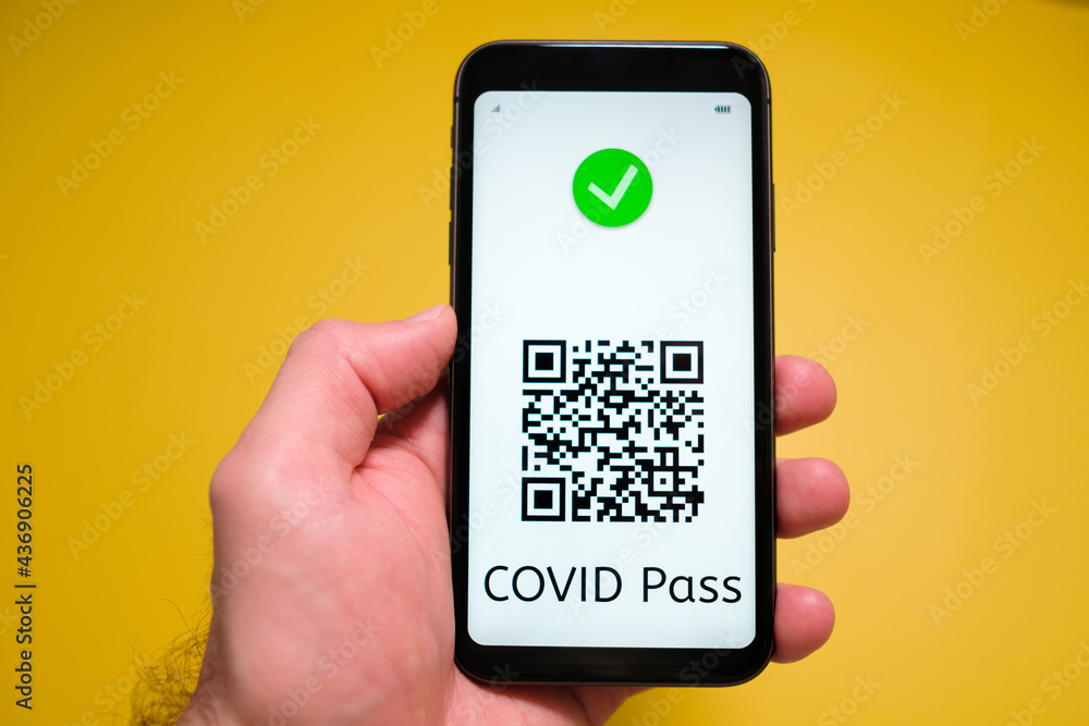 Covid pass with QR code on the screen in smartphone in mans hand on the ...