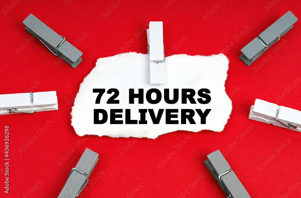 On a red background, there are clothespins and a piece of paper with ...