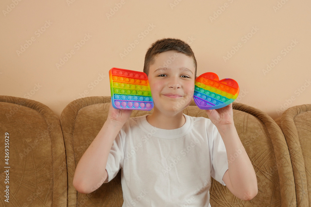 Little boy playing with a modern drink toy. Colorful and vivid toy pop ...