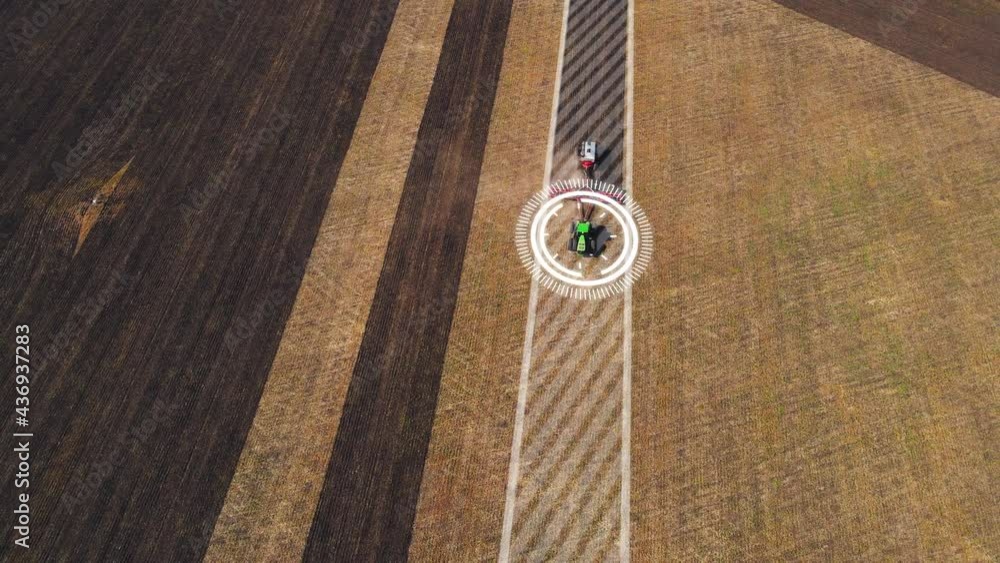 Autonomous self-driving tractor plows field, aerial top view. New ...