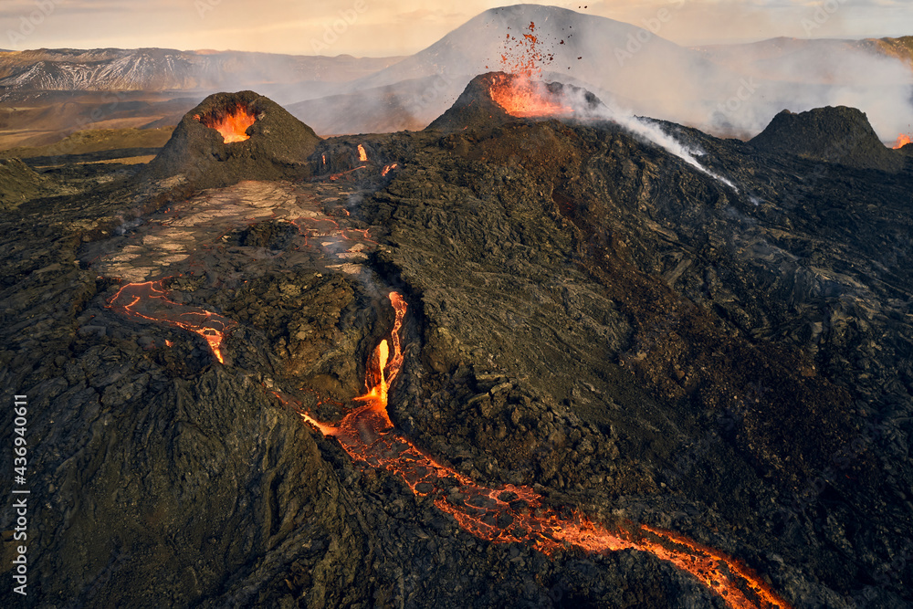 Aerial view of lava streaming down the mountain ridge, view of a river ...