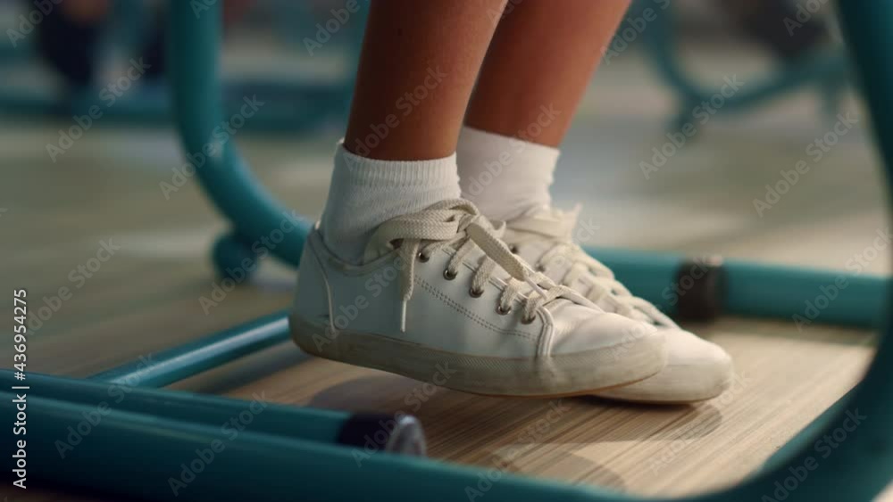Closeup girl moving legs. Female student feet under school desk in ...