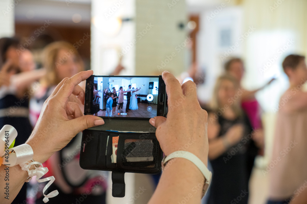 people film the most beautiful moments of a wedding with their mobile ...