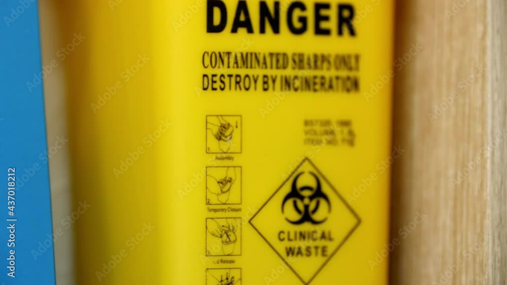 Real yellow tank with warning labels. Clinical waste are hazard for the ...
