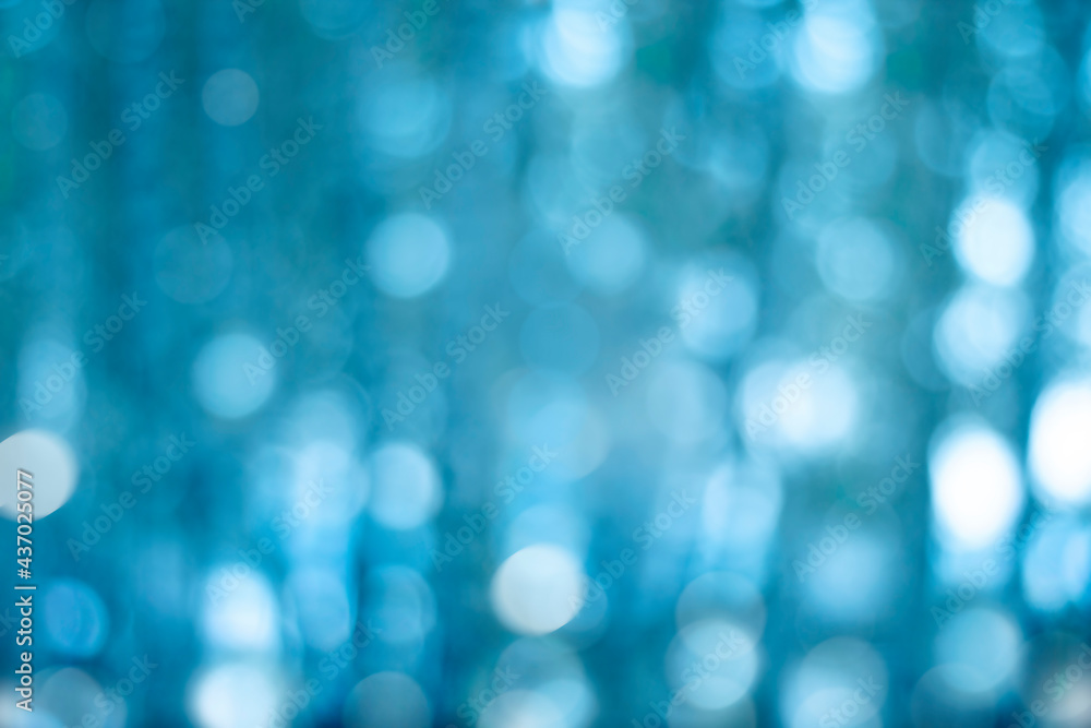Abstract blurred blue background. White defocused lights on a blue ...
