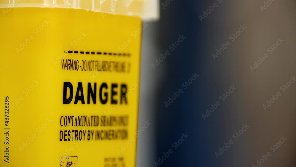 Clinical waste, danger for infection. Real yellow tank with warning ...