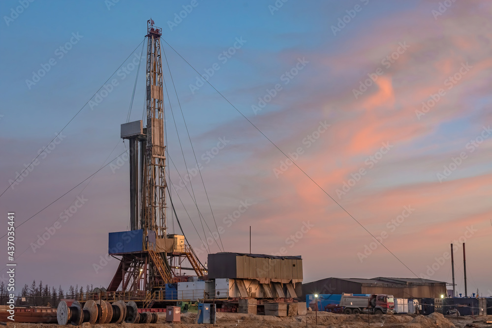 A site in the northern tundra at an oil and gas field. Drilling rig for ...