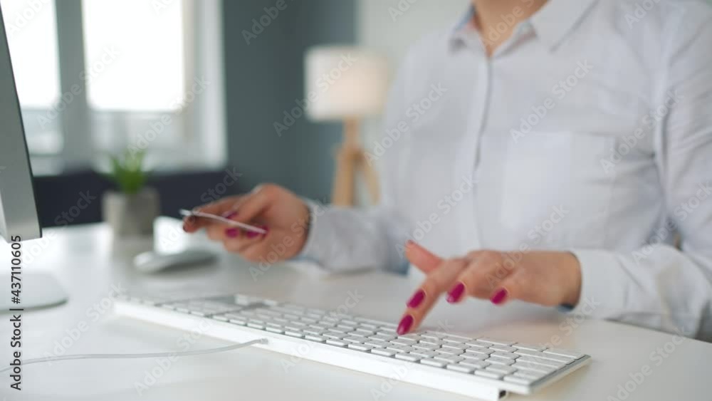 Woman typing credit card number on computer keyboard. She making online ...