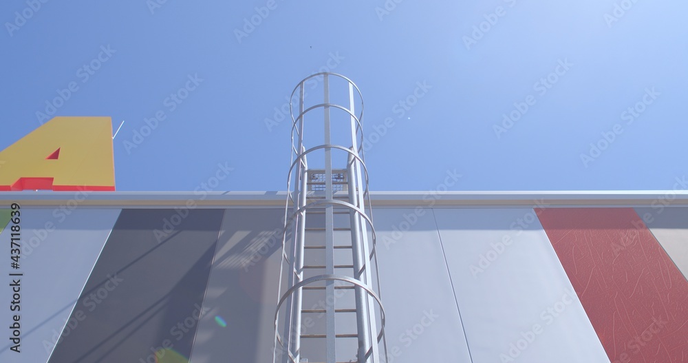 The fire escape on the store building is made of a water pipe. The path ...