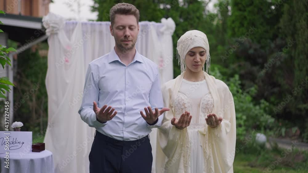 Medium shot portrait of slim beautiful Middle Eastern bride praying ...