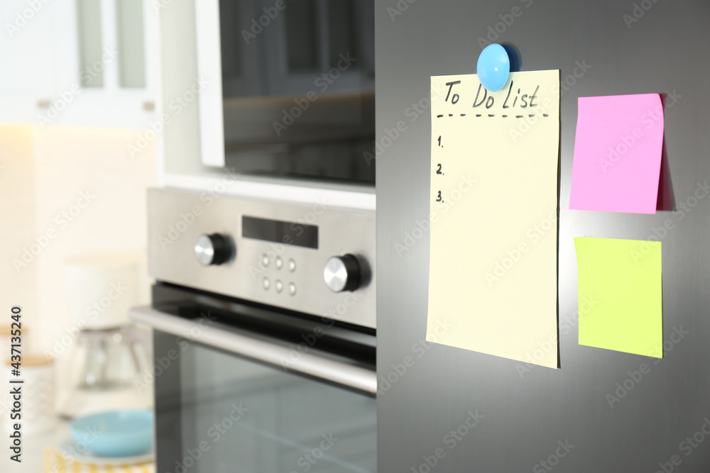 Blank To do list and sticky notes on fridge in kitchen. Space for text ...