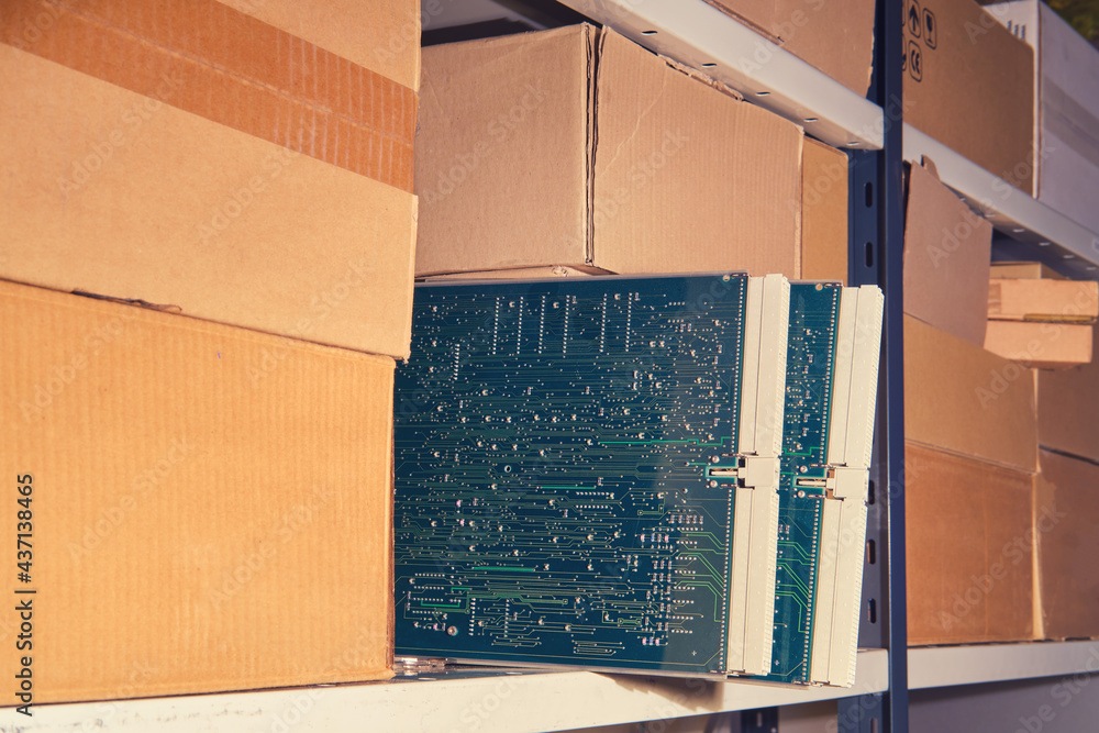 Computer parts and printed circuit boards in a warehouse among ...