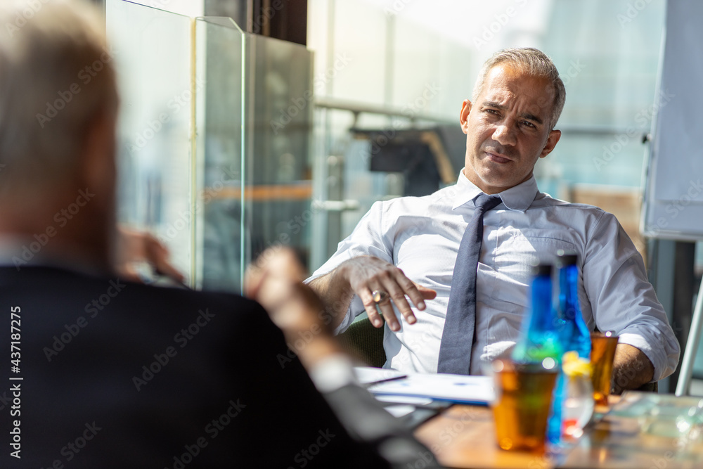 Two business men discussing idea in the office. One man is explaining ...