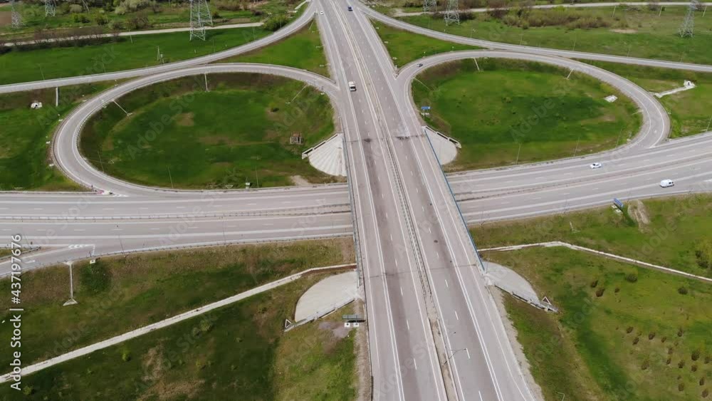 Aerial view of a suburban interchange with few moving vehicles ...