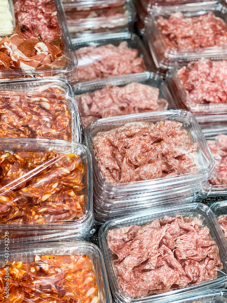 Pre packed charcuterie. Salami sausage finely sliced. On display in ...